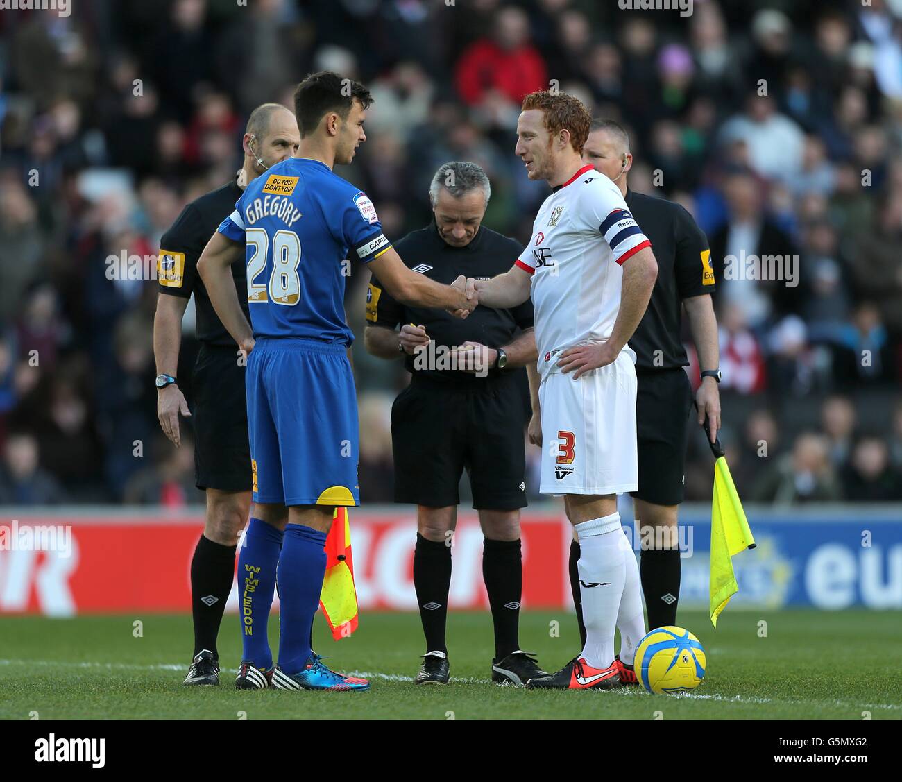 Milton Keynes Dons' captain Dean Lewington (right) and AFC Wimbledon's captain Steven Gregory ...