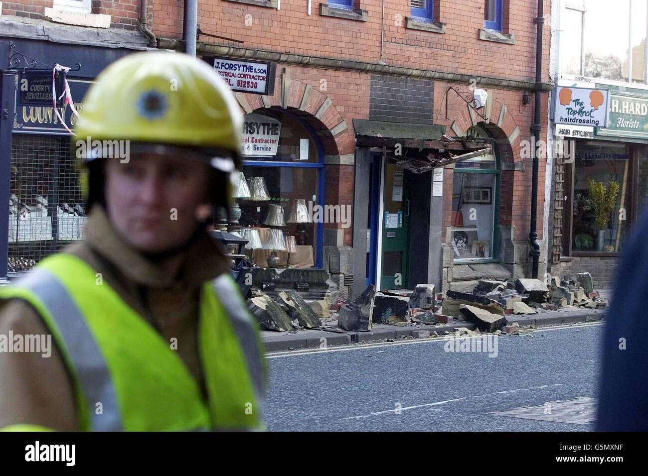 A fireman views the damage caused by high winds in Morpeth High Street ...