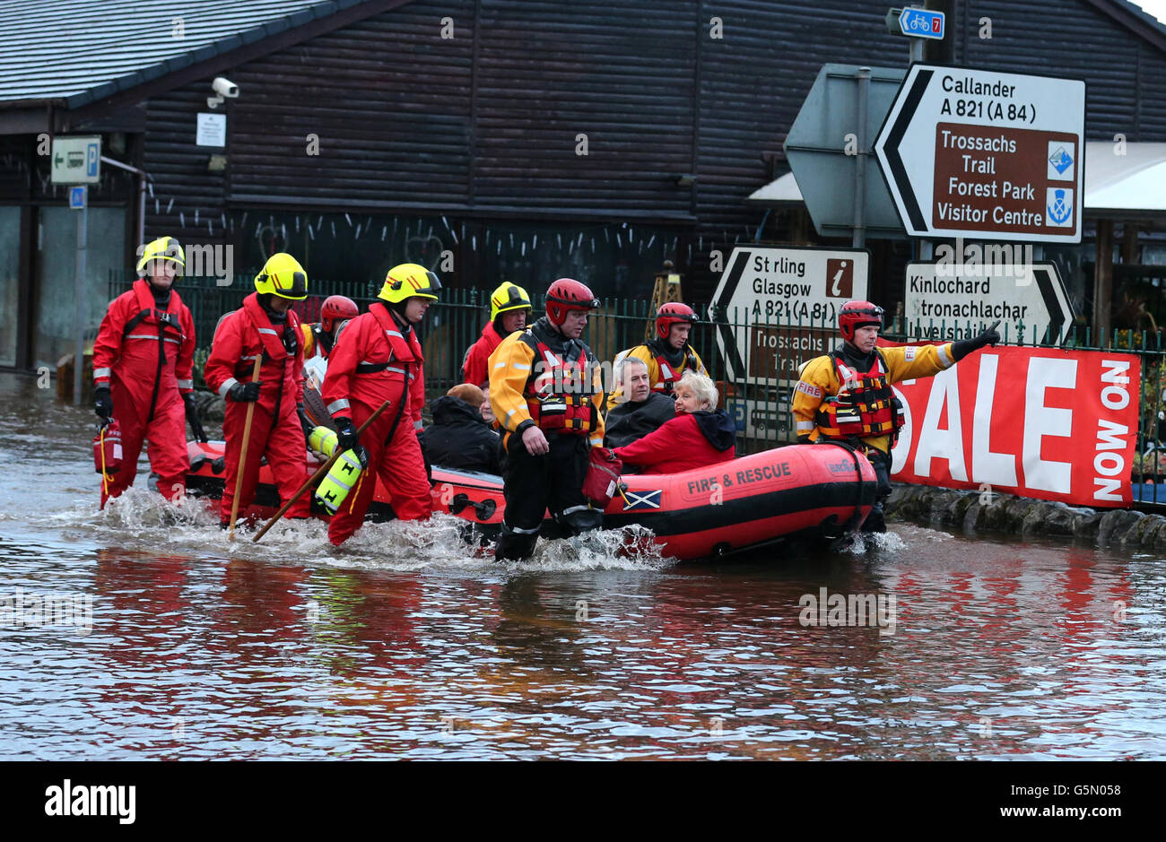 Firemen move members of the public in Aberfoyle which has been flooded ...