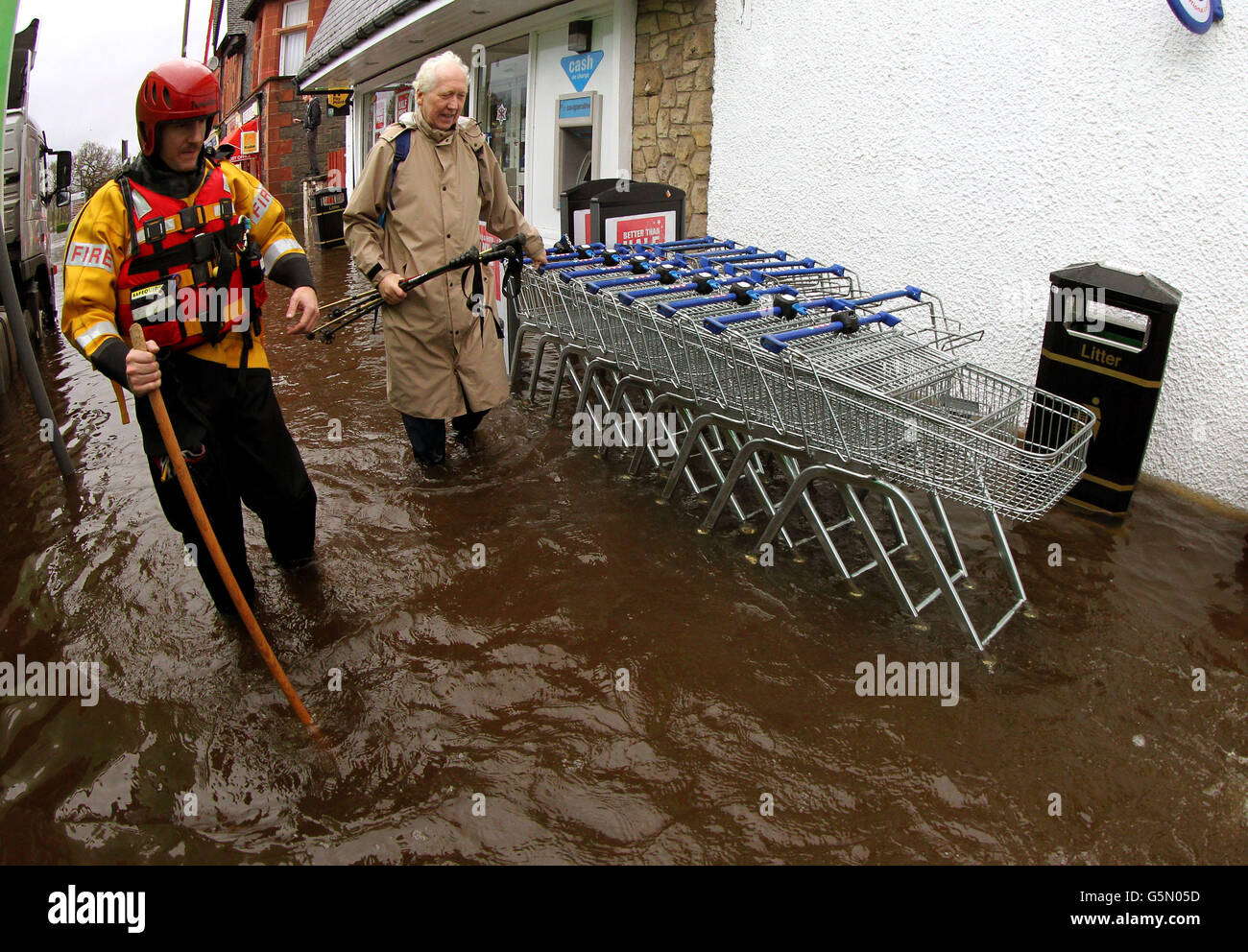 A member of the public holds onto shopping trolleys in Aberfoyle which ...