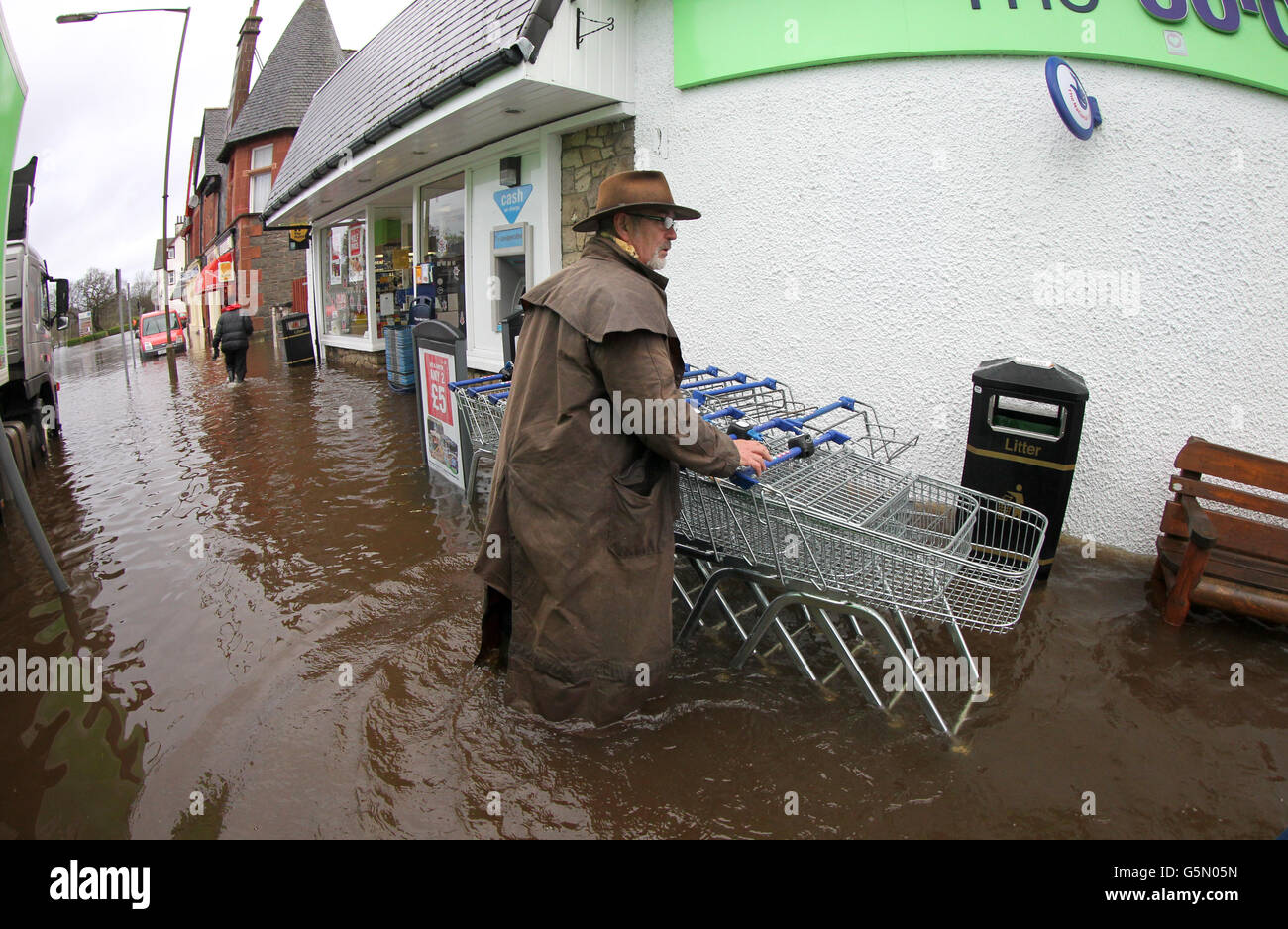 A member of the public holds onto shopping trolleys in Aberfoyle which ...