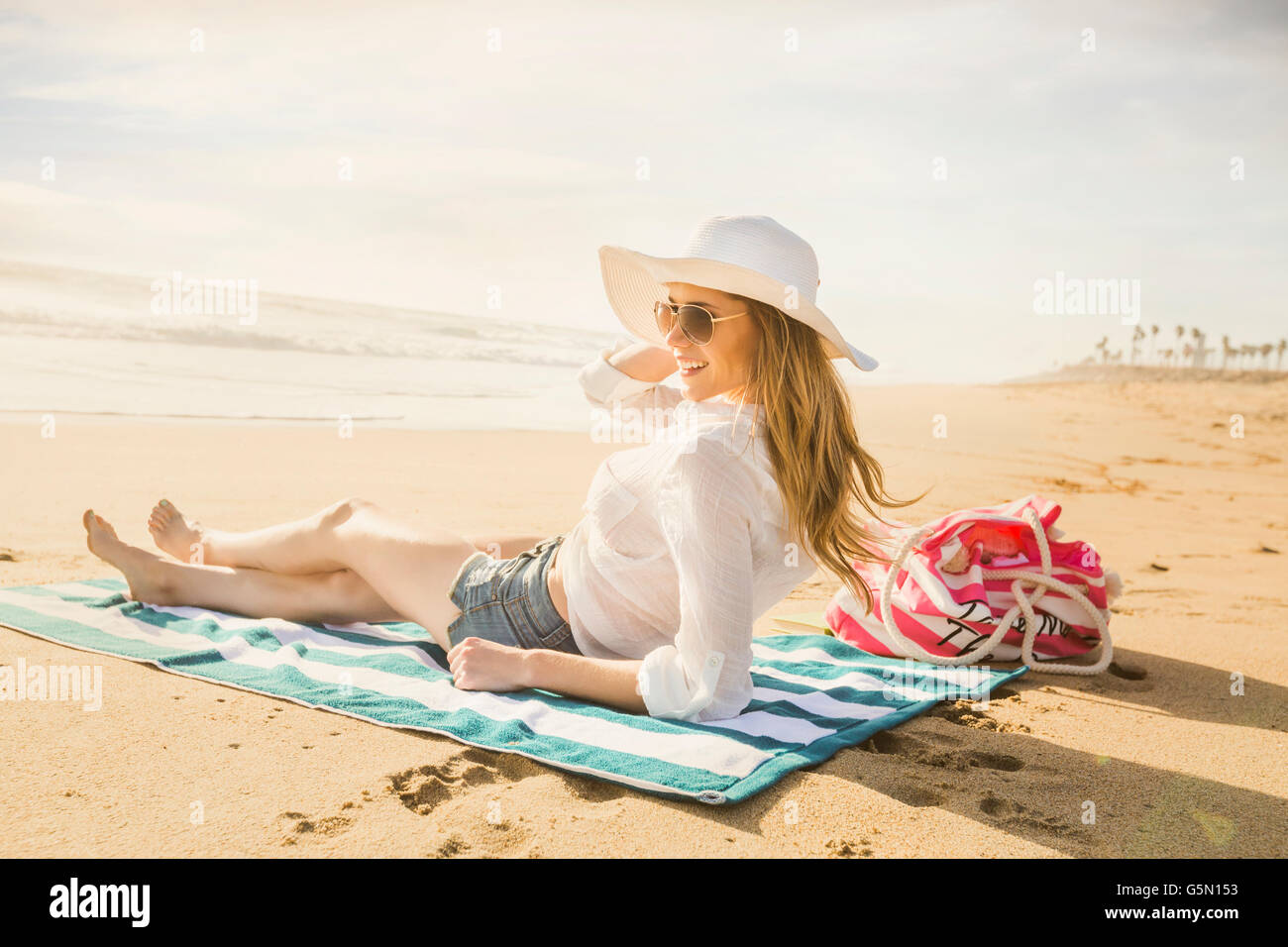 Caucasian woman laying on beach Stock Photo - Alamy