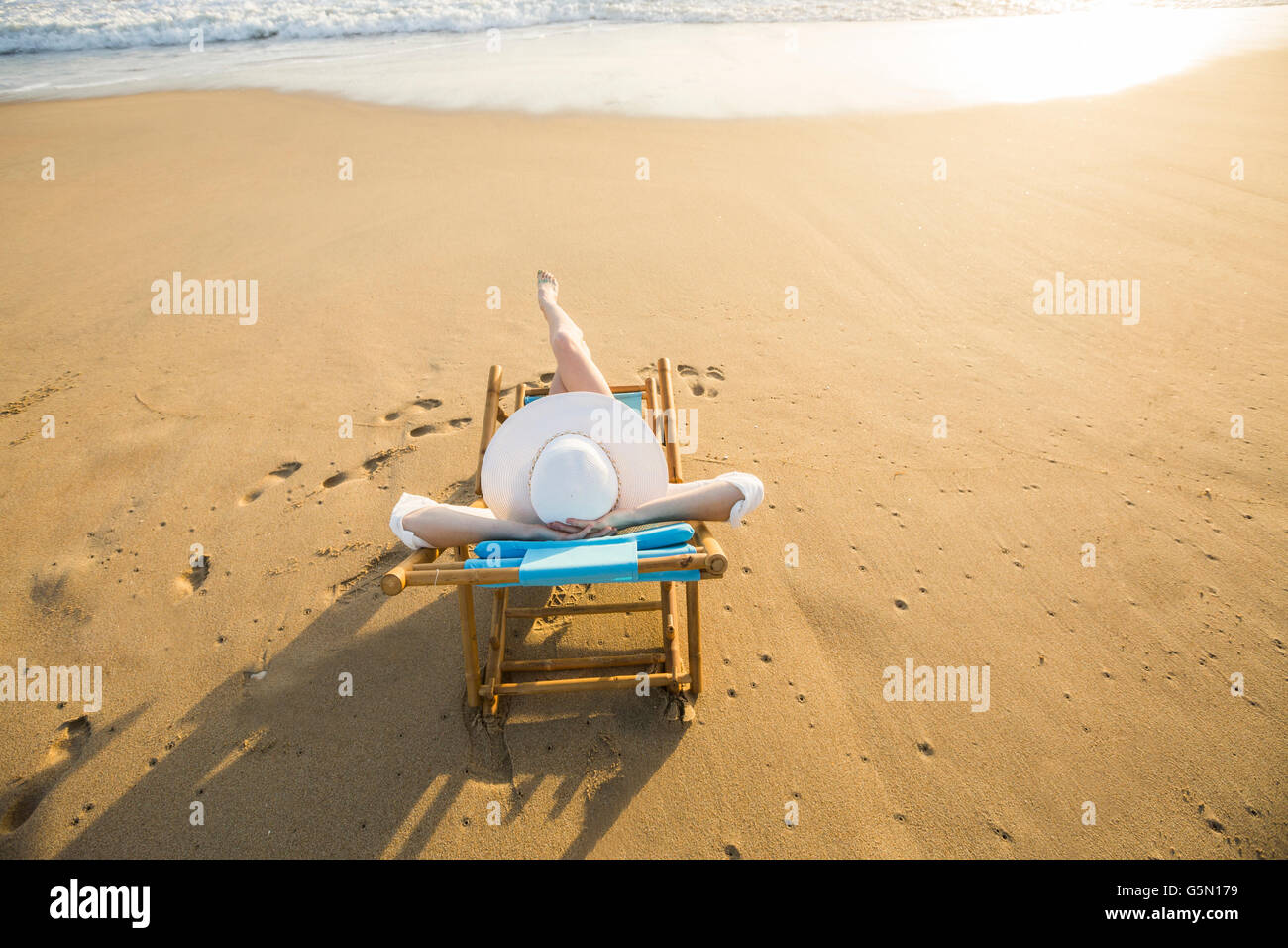 Caucasian woman laying on beach Stock Photo - Alamy