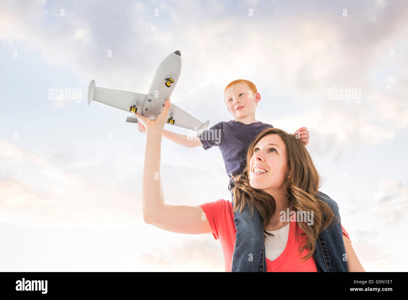 Caucasian mother and son flying toy airplane Stock Photo - Alamy
