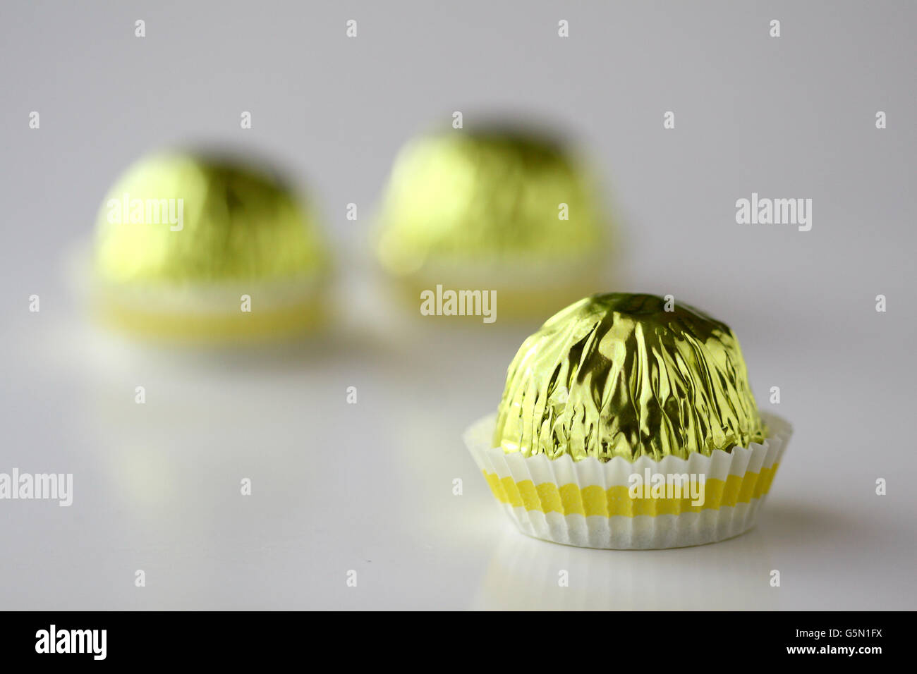 Close up of Chocolates individually wrapped in metallic wrapper against ...