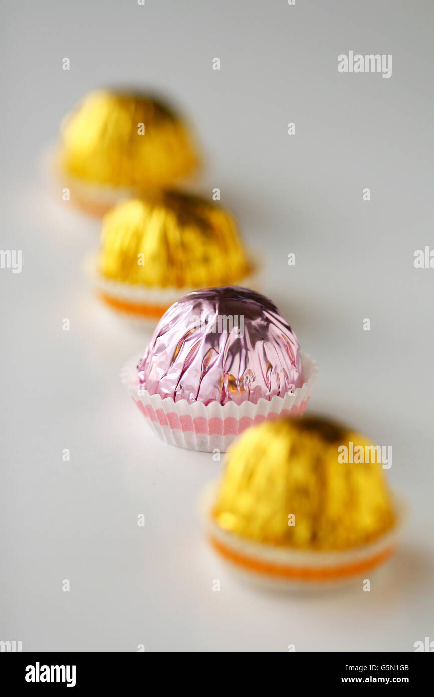 Close up of Chocolates individually wrapped in metallic wrapper against ...