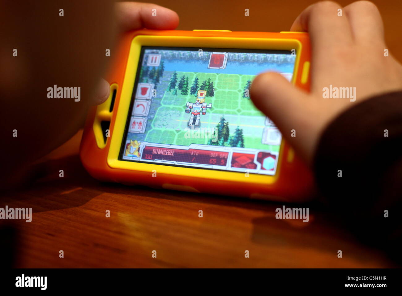 Young child playing games on the iPhone Stock Photo - Alamy