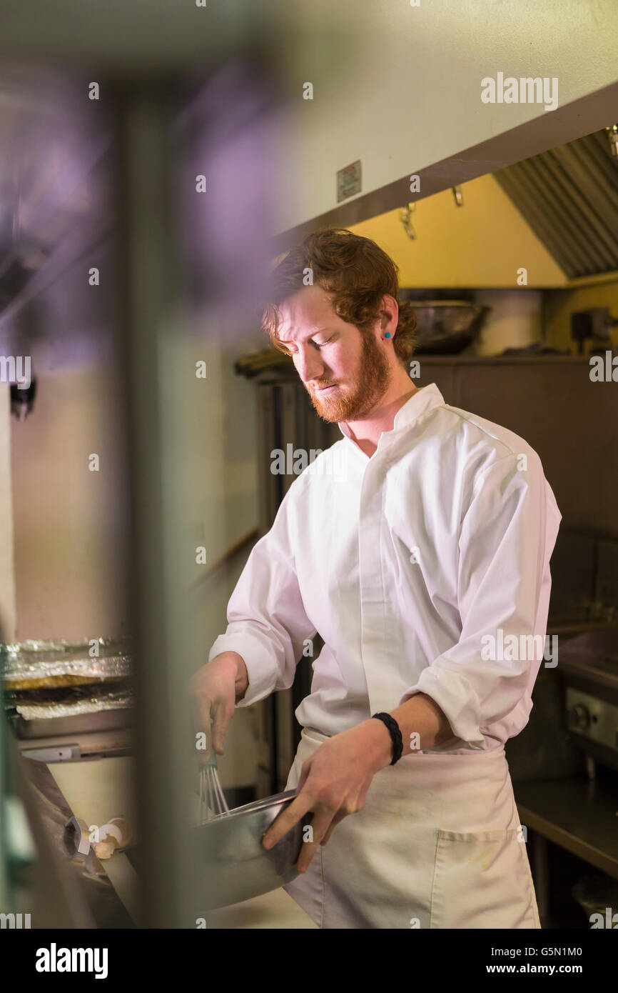 Caucasian chef reading orders in restaurant kitchen Stock Photo - Alamy