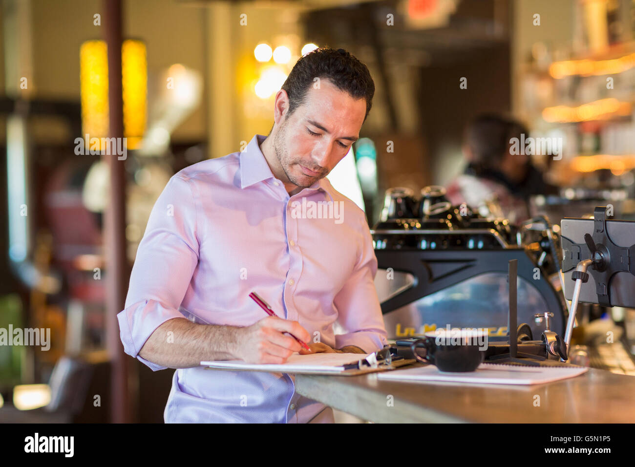 Entrepreneur man drinking coffee writing hi-res stock photography and ...