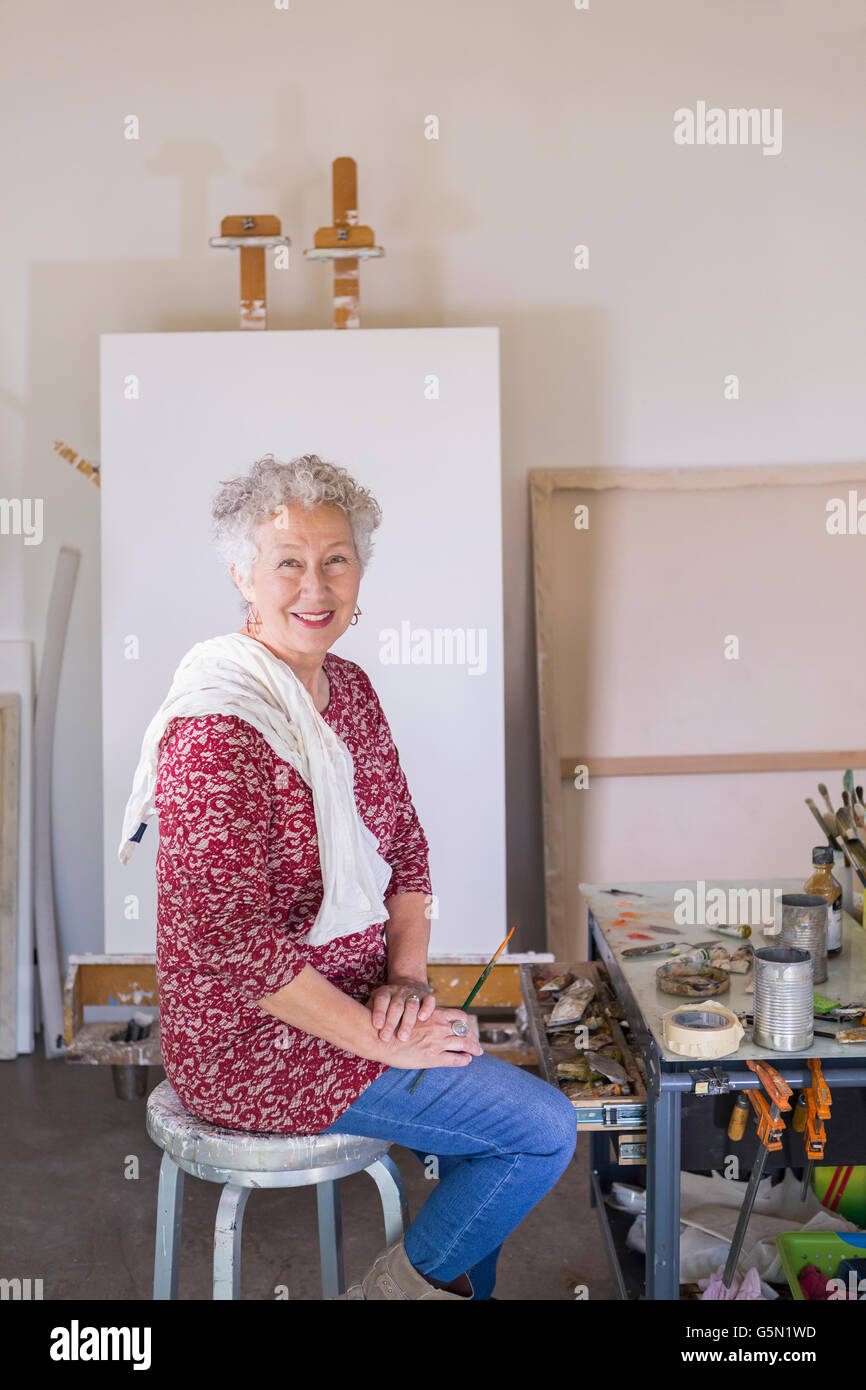 Artist smiling in studio Stock Photo - Alamy