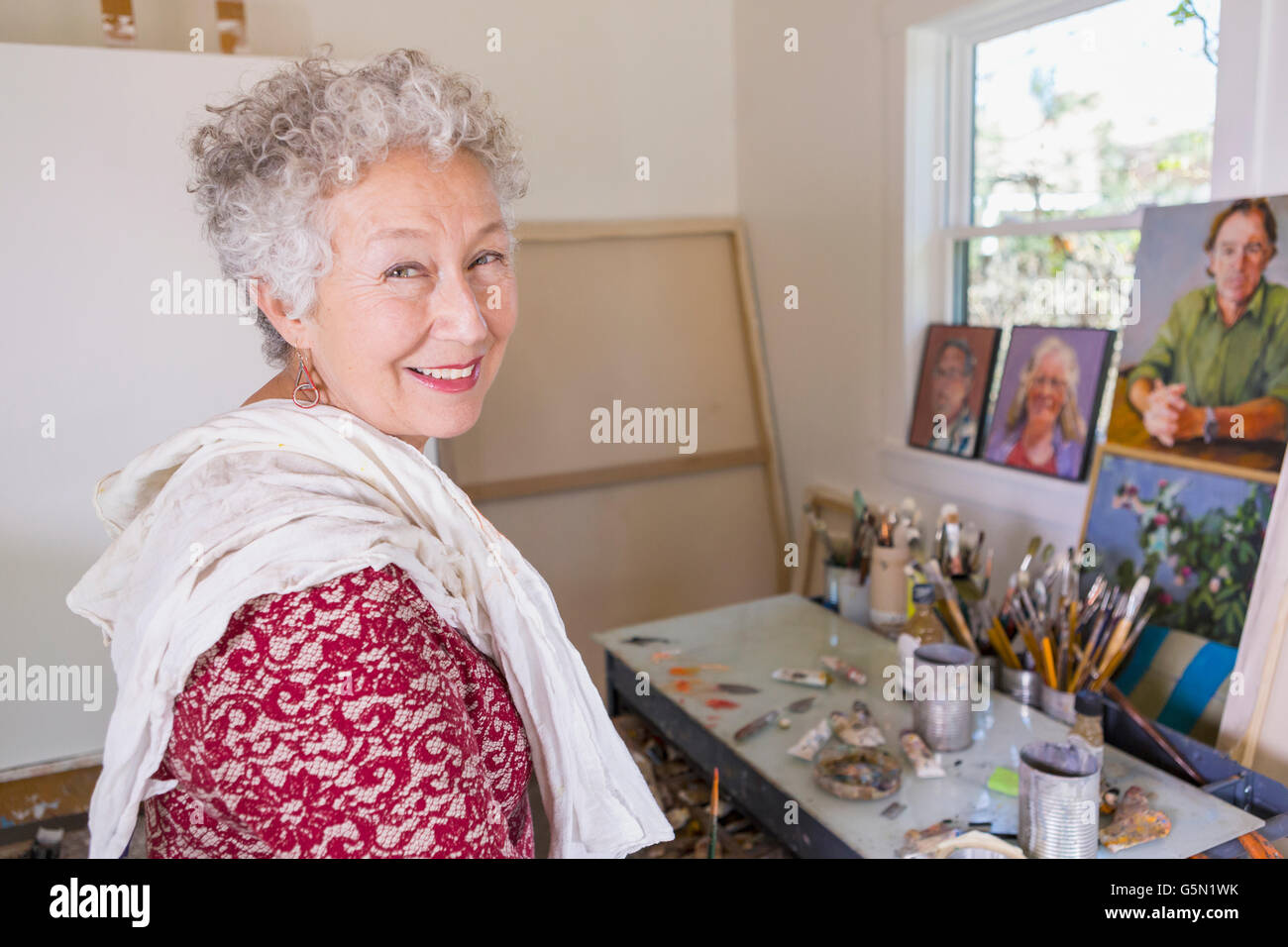 Artist smiling in studio Stock Photo - Alamy