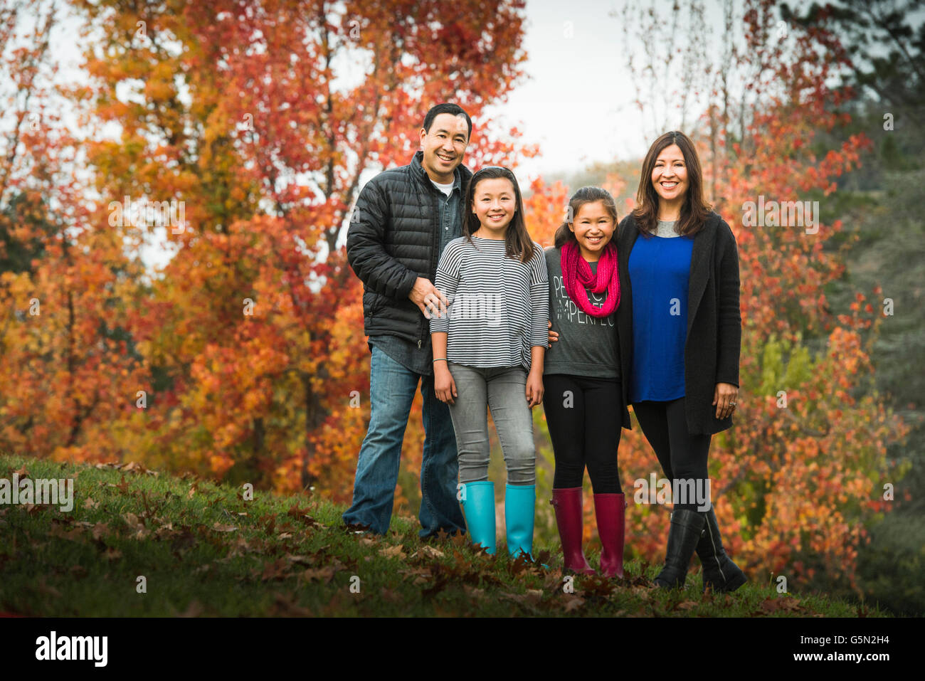 Family smiling on autumn hillside Stock Photo - Alamy