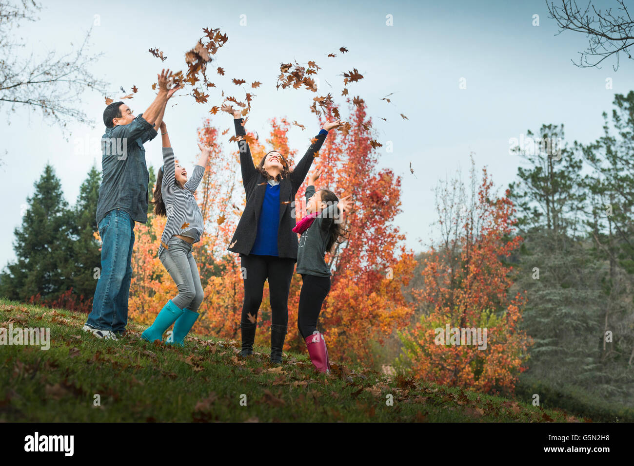 Two girls throwing leaves hi-res stock photography and images - Alamy