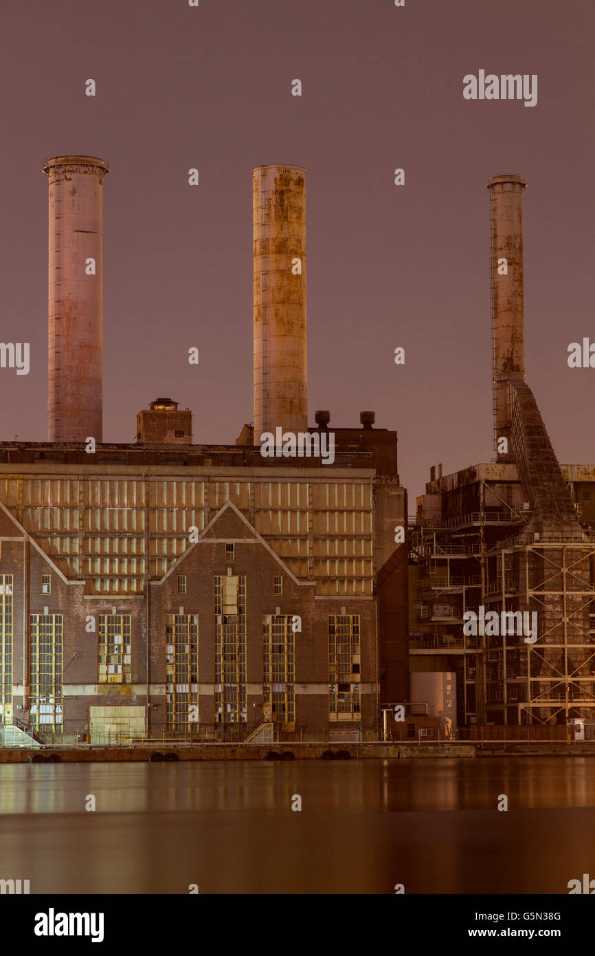 Factory smokestacks lit up at night Stock Photo - Alamy