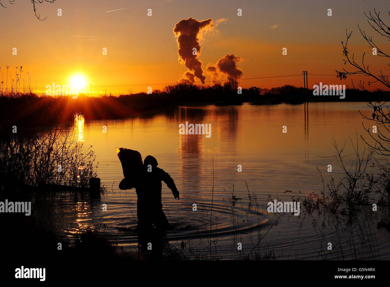 The power stations of the Selby area send smoke into the sky as a man ...