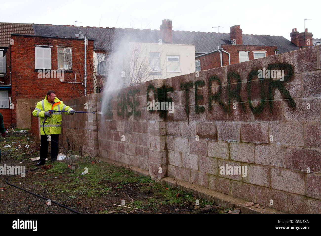A council workman removes Graffiti appearing to glorify the September ...