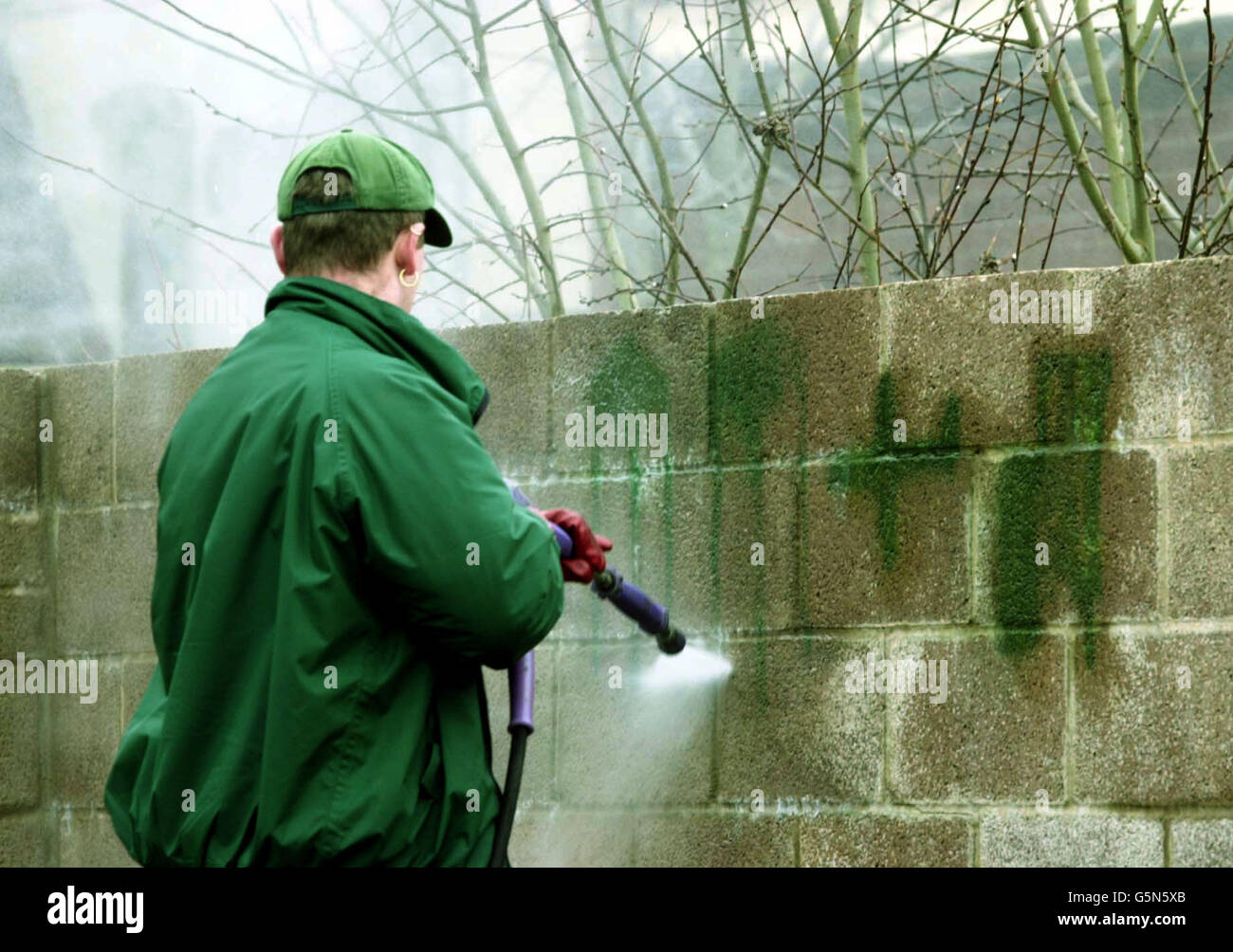 A council workman removes Graffiti appearing to glorify the September ...