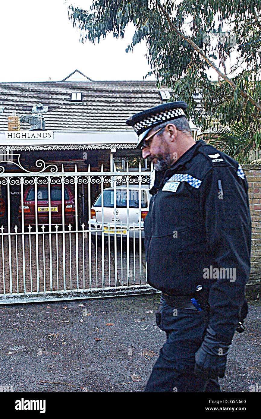 A policeman patrols past Rolf Harris Thames riverside home in Bray ...