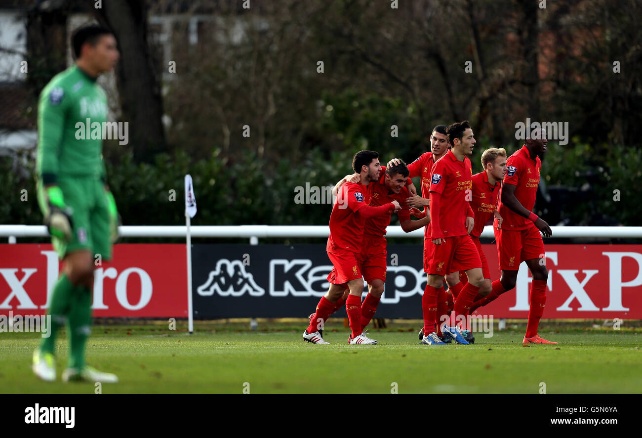 Liverpool's Adam Morgan (second left) is mobbed by team mates after ...