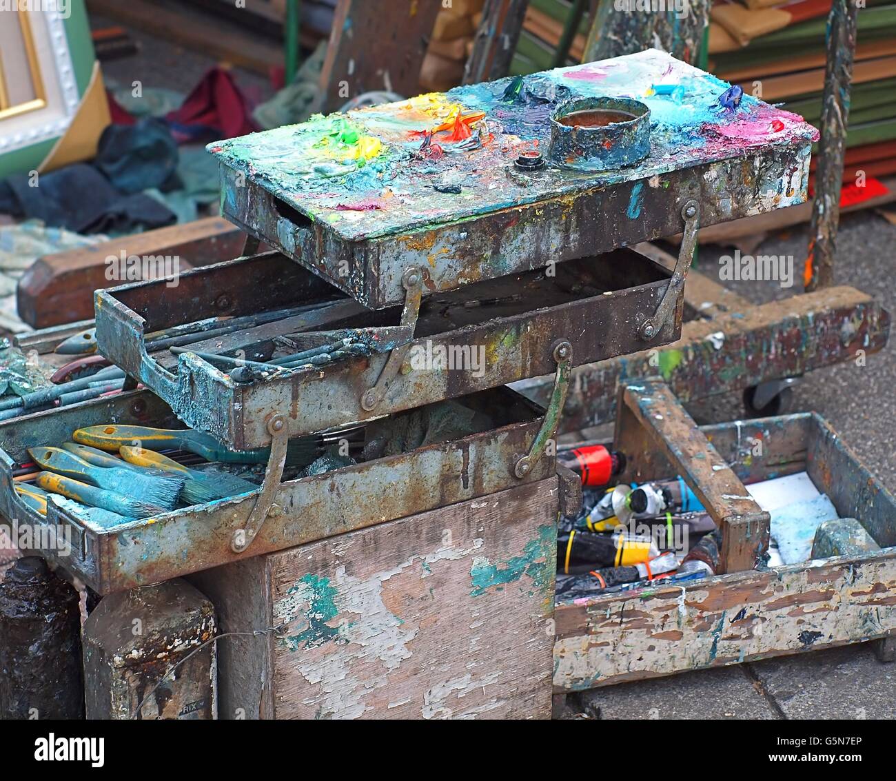 Trays with paints and brushes and a color mixing area of an outdor ...