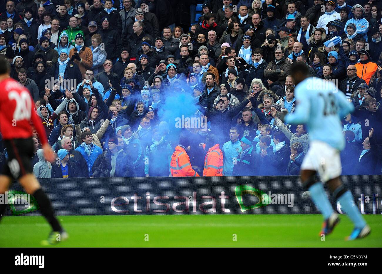Manchester City fans let off a blue flare in the stands Stock Photo - Alamy
