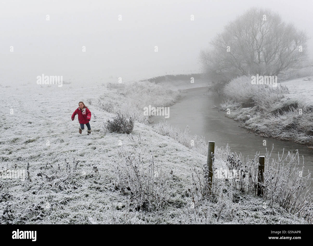 Emily Cowell, aged nine, runs along a frost covered path near Thirsk ...