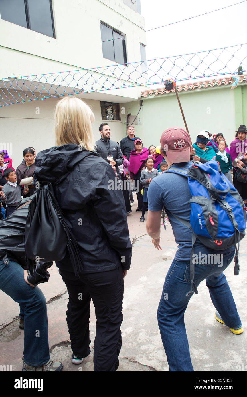 Diverse group of people playing pinata in a courtyard Stock Photo - Alamy