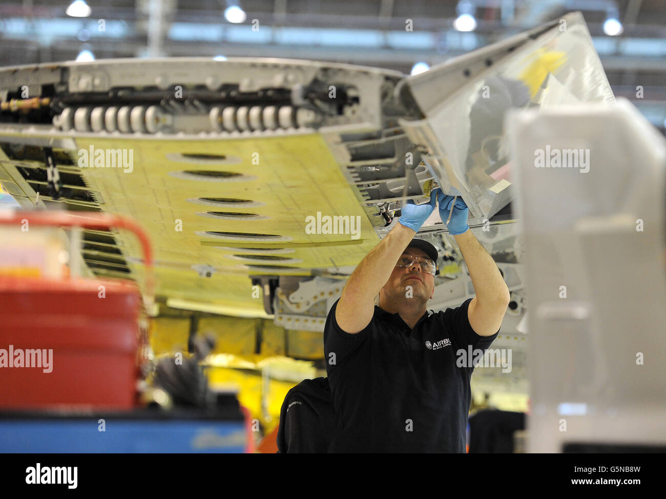 Engineers work on the wings for the Airbus A320, a Airbus UK in ...
