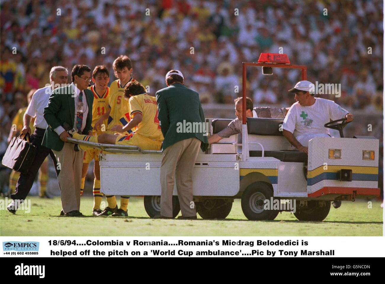 Romanias miodrag belodedici helped off pitch on world cup ambulance hi ...