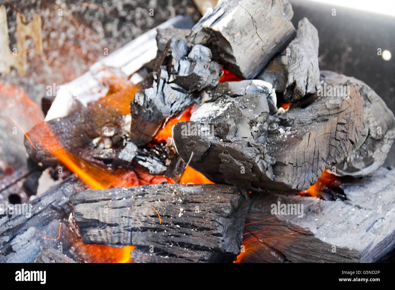 Photograph of some wood charcoal pieces and fire flames Stock Photo - Alamy