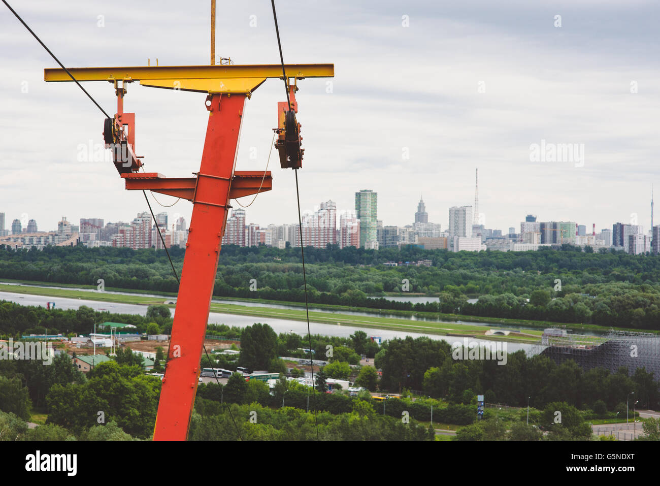 rusty old red yellow ski lift against the backdrop of the Moscow city ...