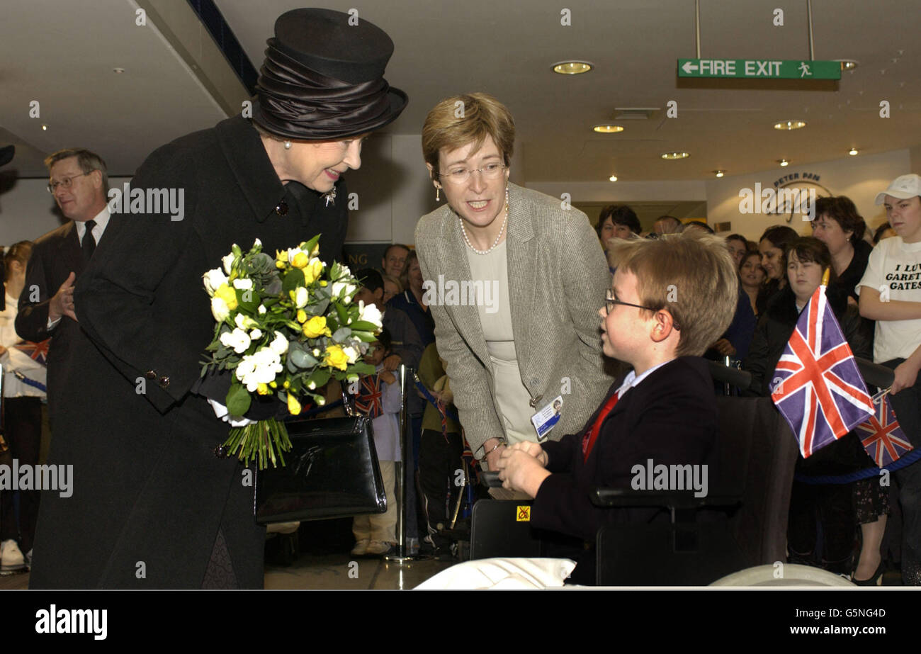 Britain's Queen Elizabeth II accepts a bouquet from George Colvin-Slee ...