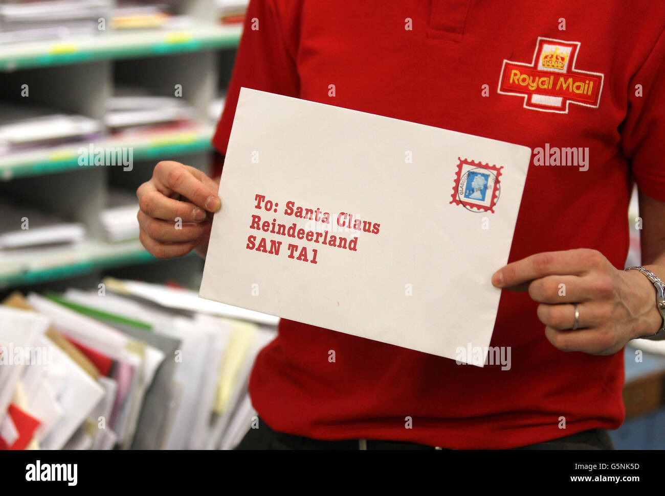 Royal Mail postal worker Helen Cameron sorts mail, including a letter ...