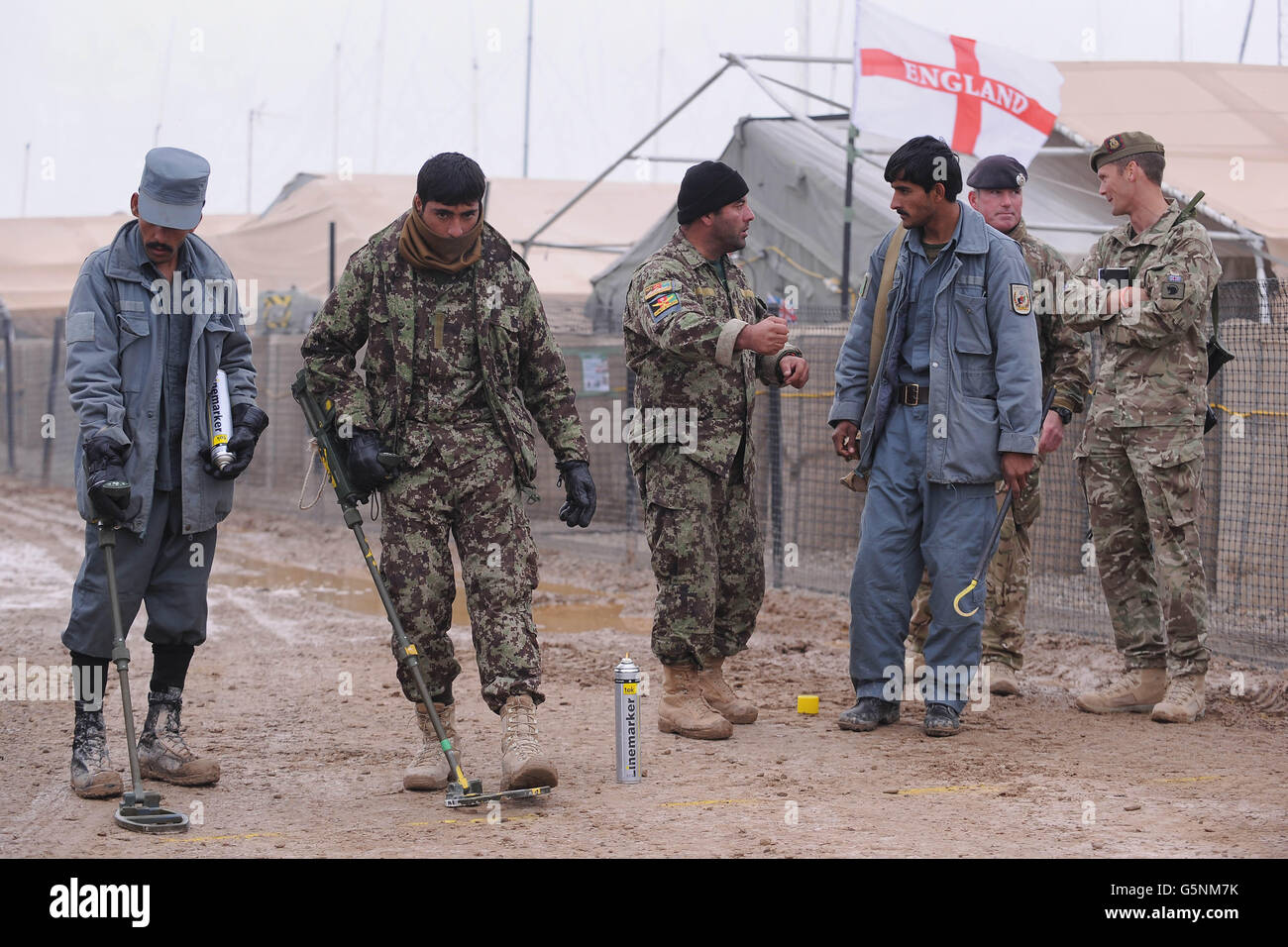 Sergeant Waysidin (centre) teaches members of the Afghan National Army ...