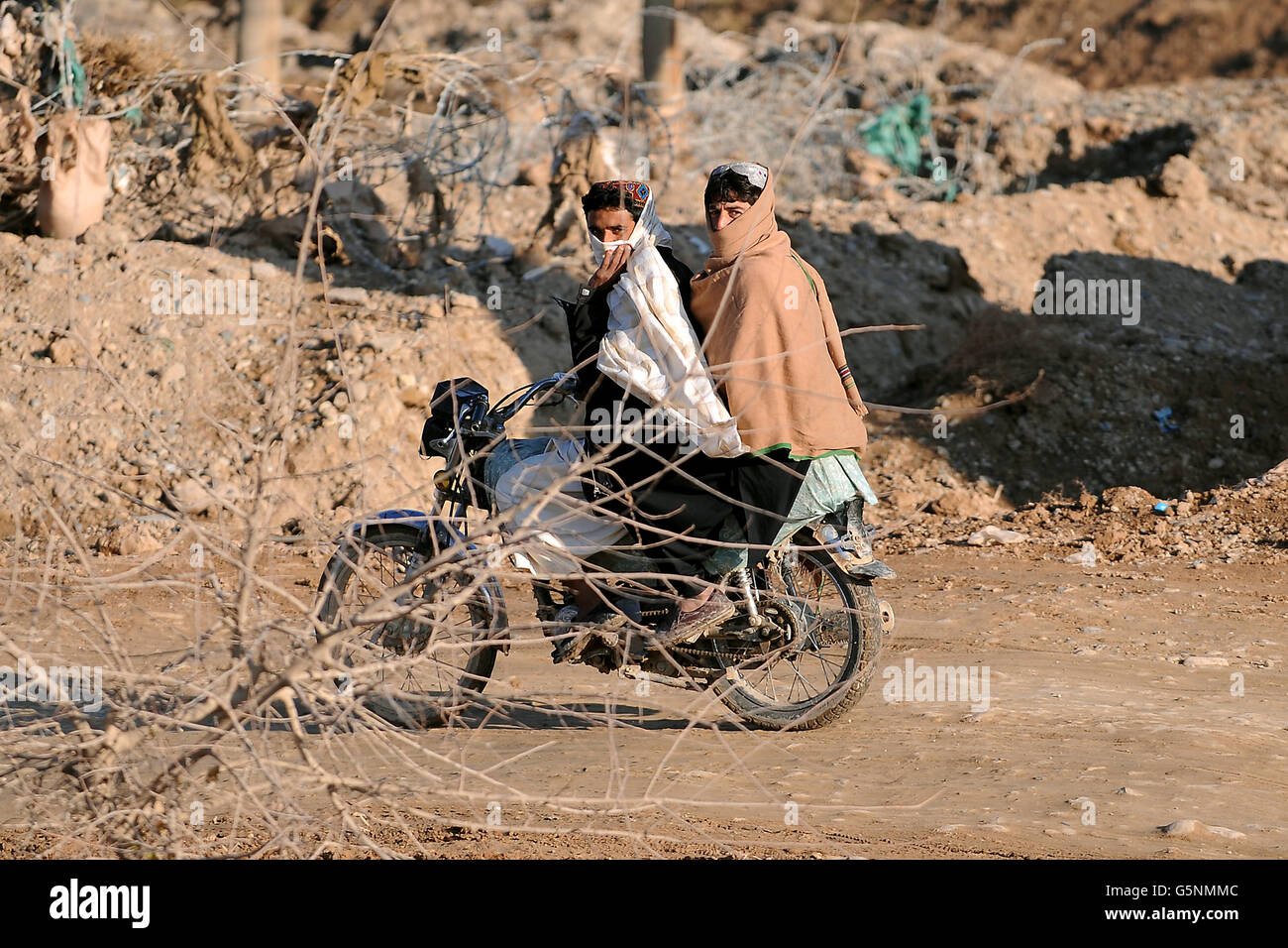 An Afghan locals ride past checkpoint Chara-He in Helmand Province ...