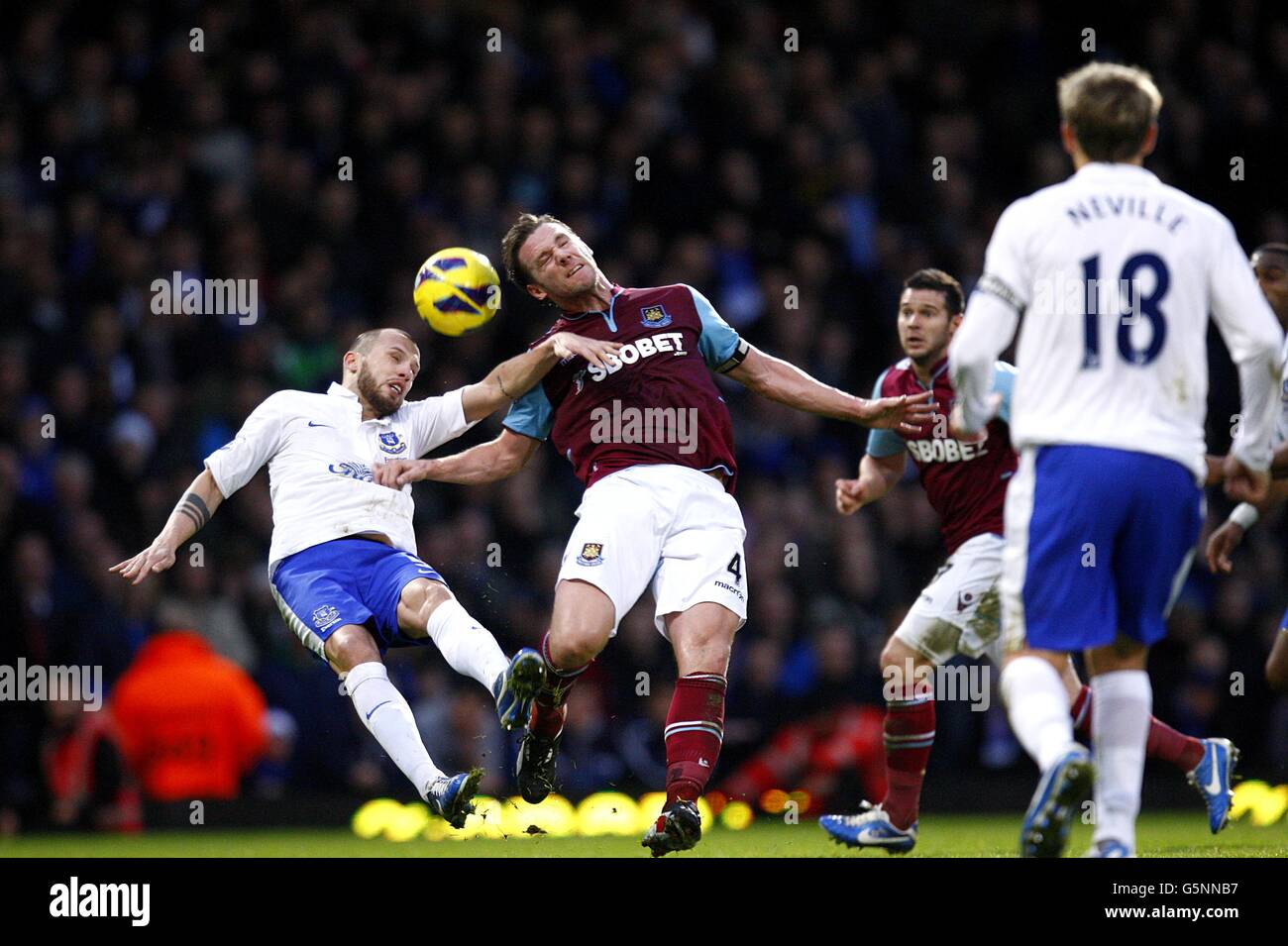 Everton's Johnny Heitinga (left) and West Ham United's Kevin Nolan ...