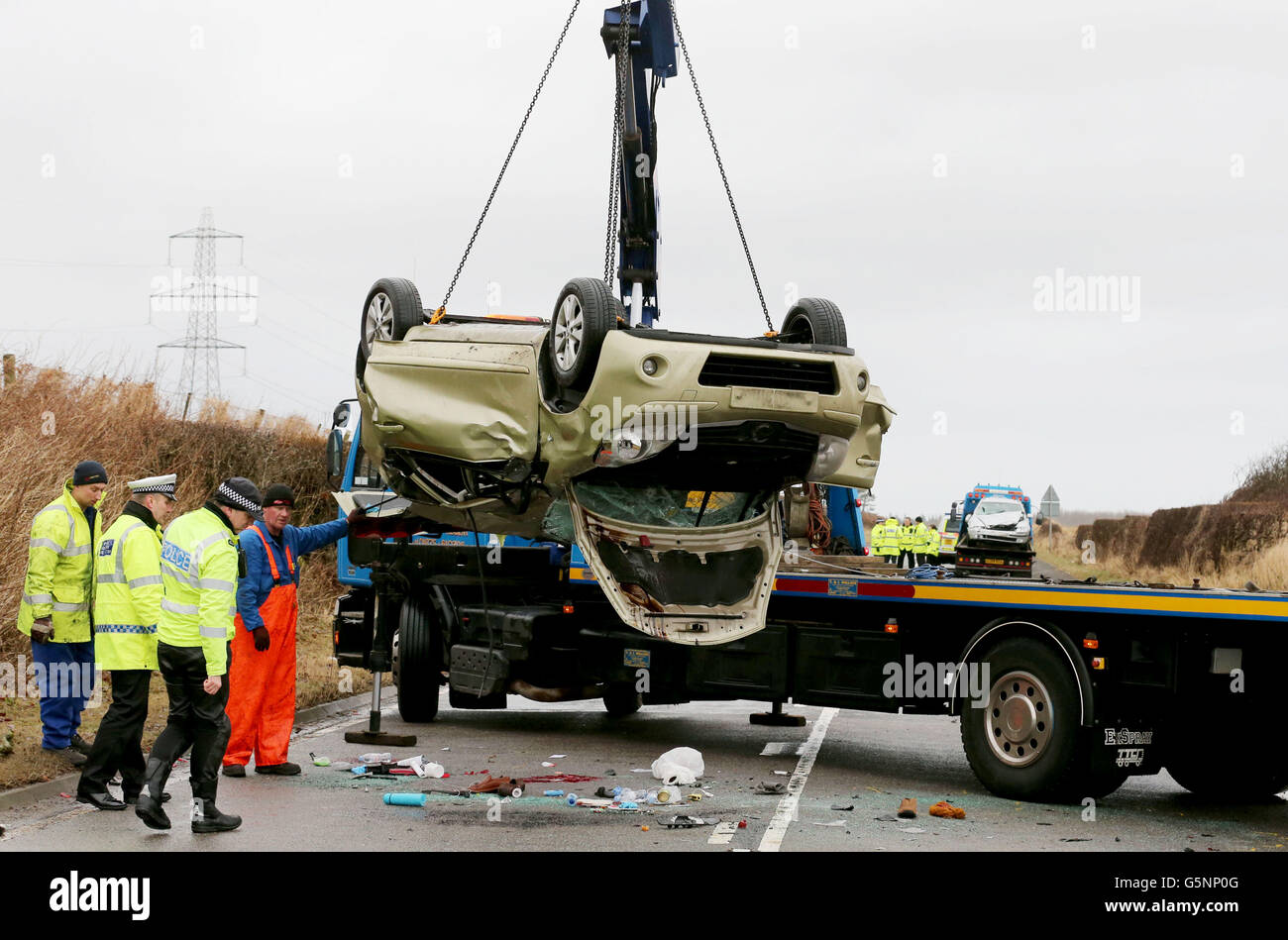 Crash investigators view a gold Nissan Note as it is removed from the ...