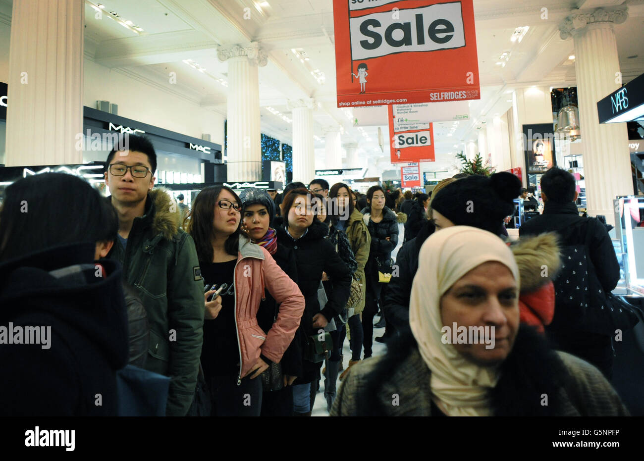 Shoppers queue for the Prada counter in Selfridges department store in ...