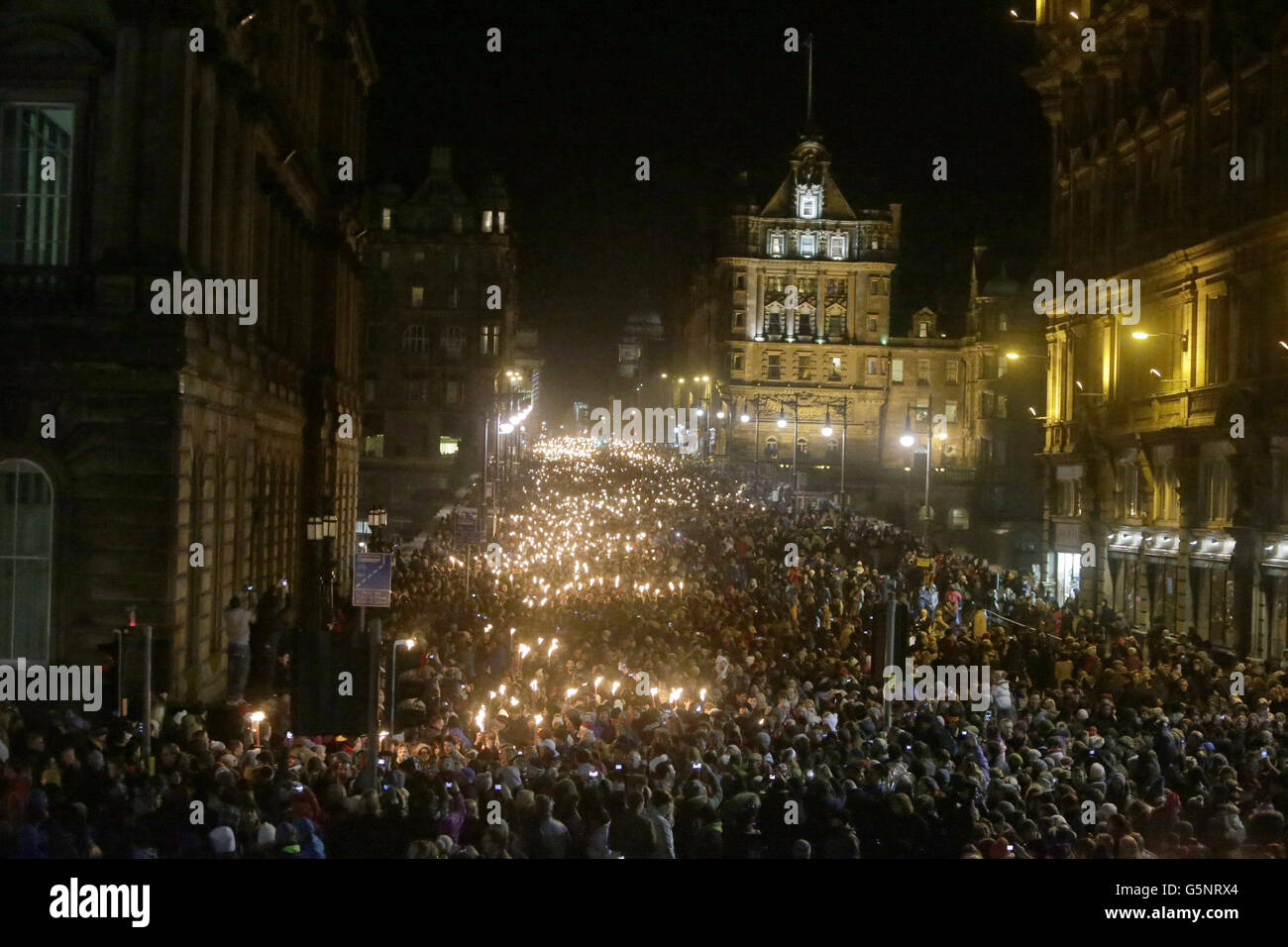 People take part in a torchlight procession through Edinburgh as part ...