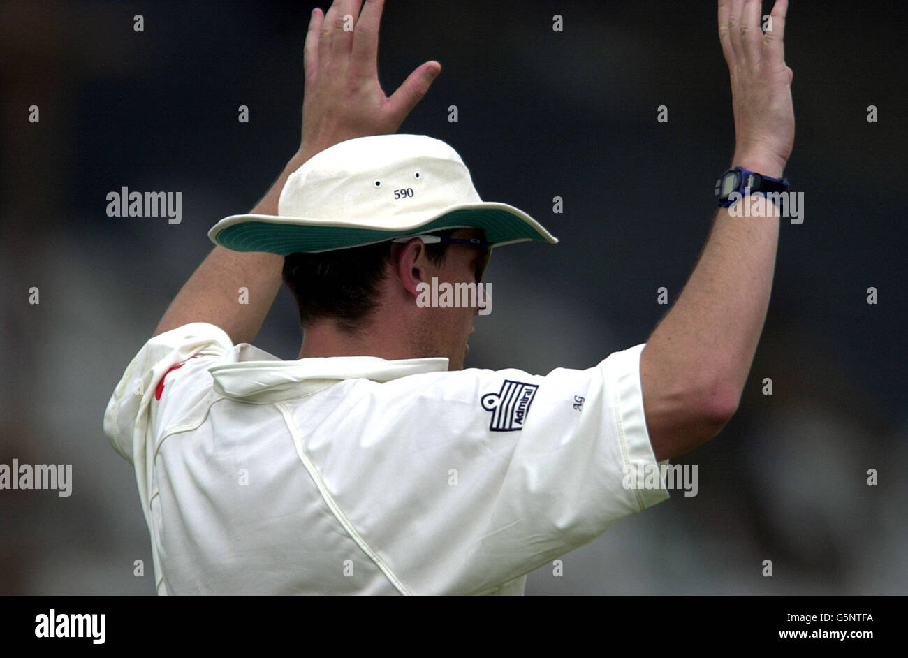 England's Ashley Giles acknowledges the other team players in the game ...