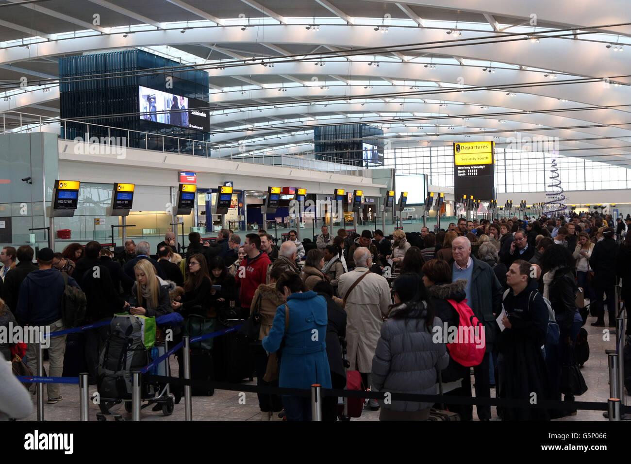 Passengers wait to be rebooked in Terminal 5 as thick fog leads to ...