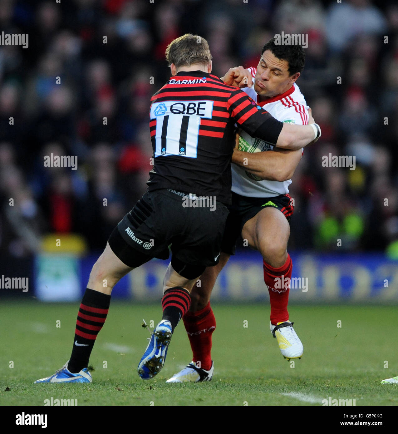 Saracens' David Strettle tackles Munsters' Doug Howlett during the ...