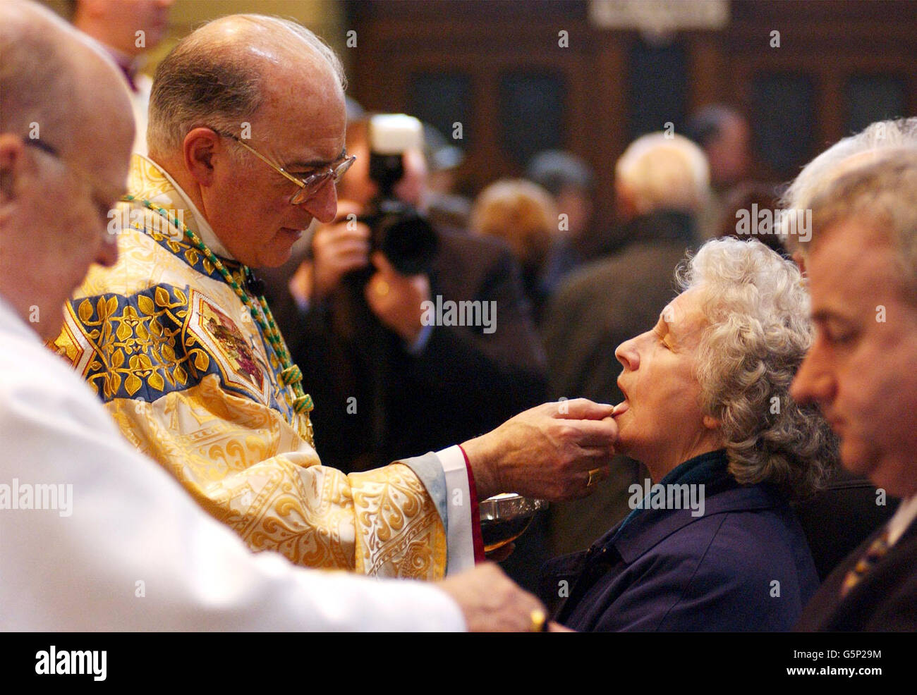 The Most Reverend Mario Joseph Conti performing Holy Communion at the ...