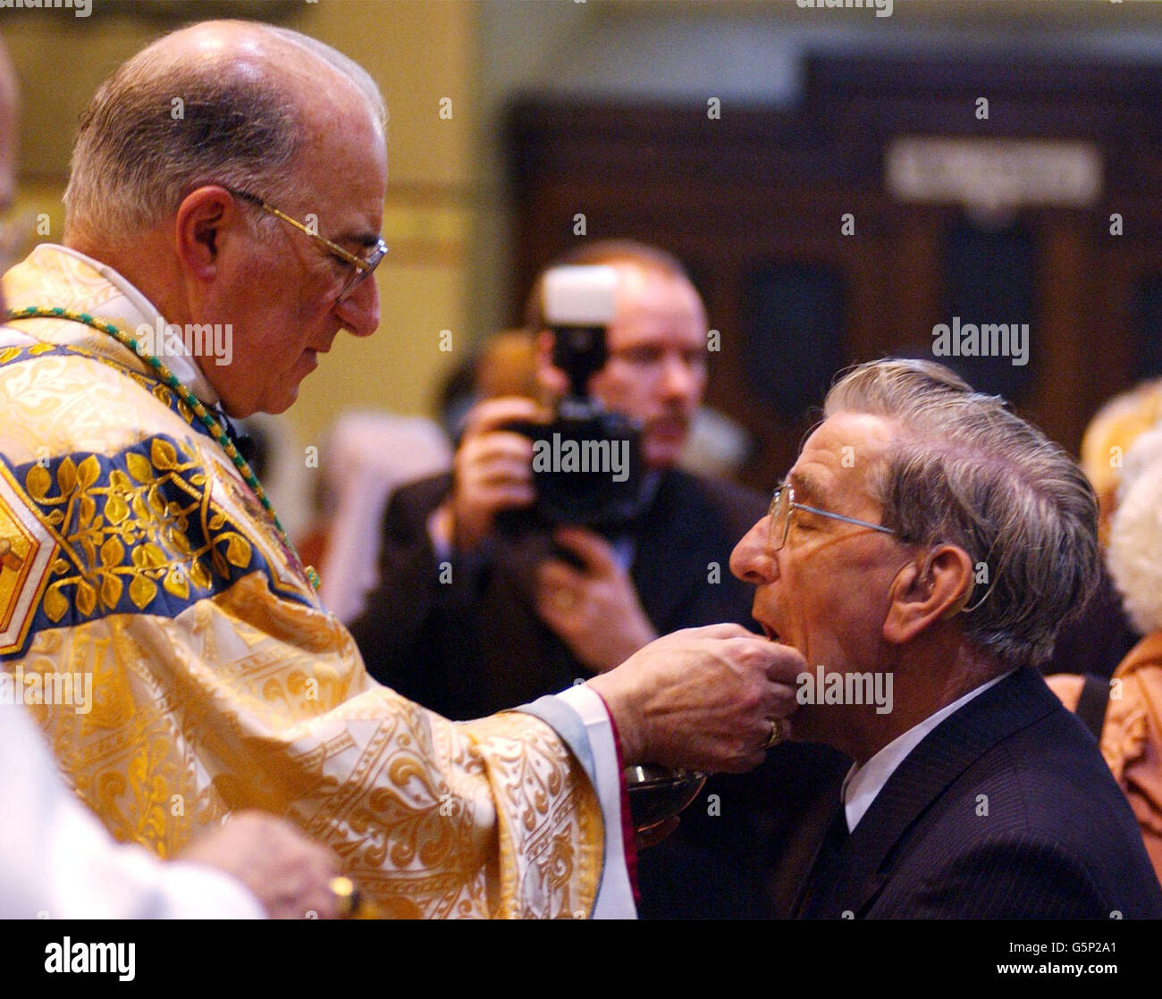 The Most Reverend Mario Joseph Conti performing Holy Communion at the ...
