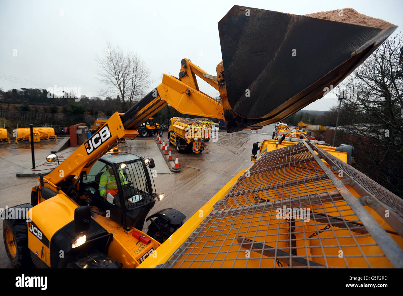 Richard Lilley who works for contractor May Gurney loads salt on to ...