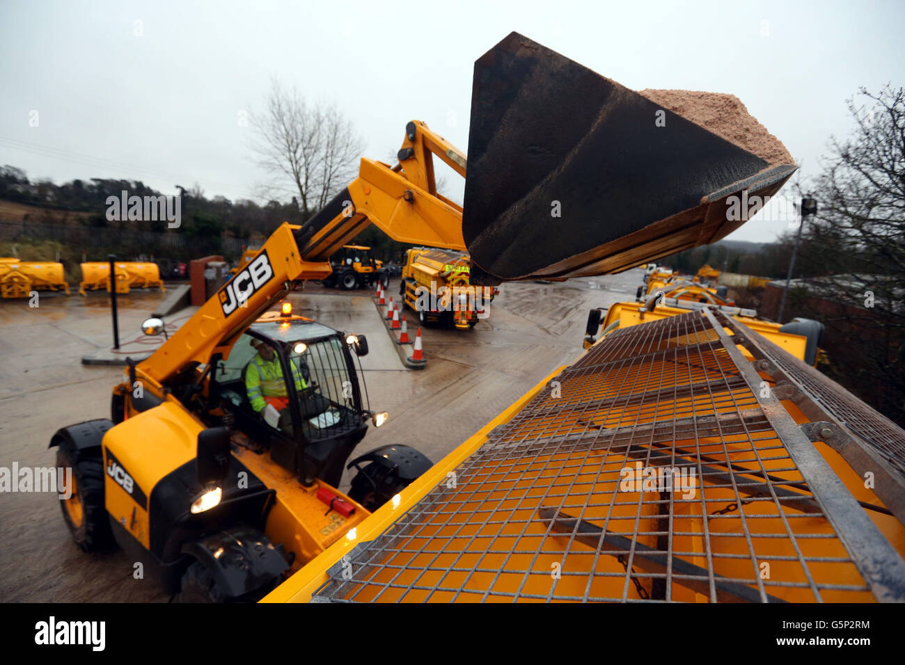 Richard Lilley who works for contractor May Gurney loads salt on to ...