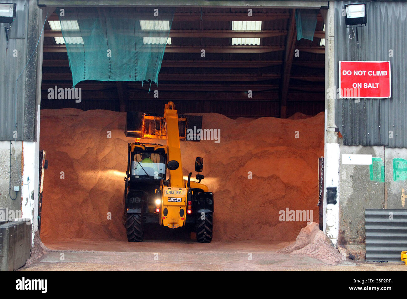 Richard Lilley who works for contractor May Gurney loads salt at Surrey ...