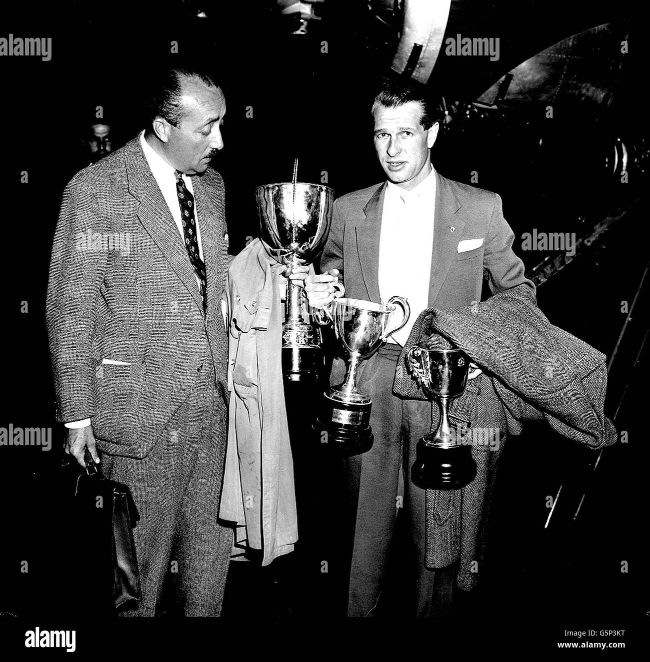 Peter Collins (R) arrives in London with Trophies in hand Stock Photo ...