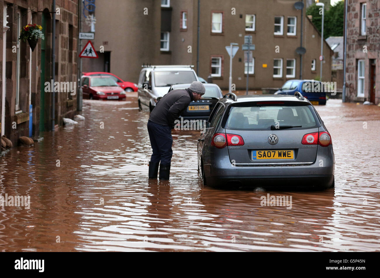 Winter weather Dec 23rd. A man views his flooded car on the high street ...