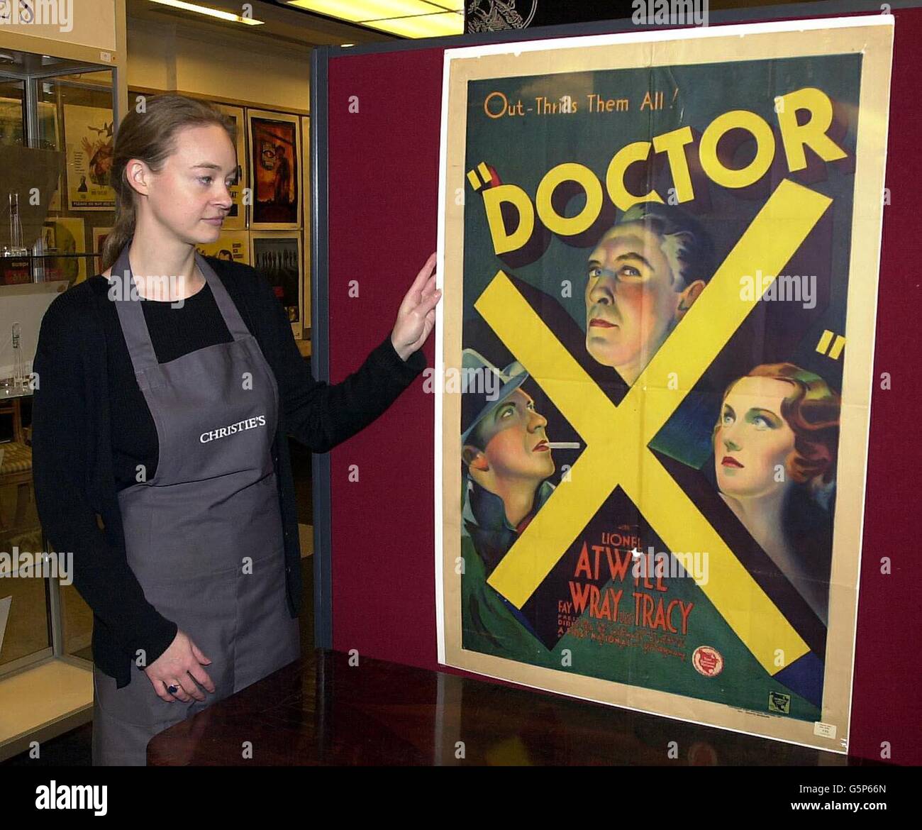 Christie's porter Suzanne Irvine 29, from Bedford looking at a poster ...